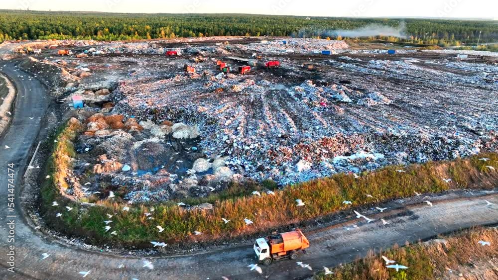 Garbage truck unloads rubbish. Landfill with solid household waste ...