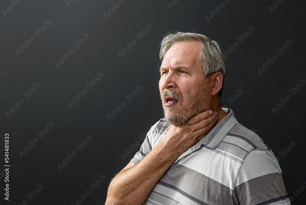 Adult male with an attack of suffocation or sore throat on a black ...