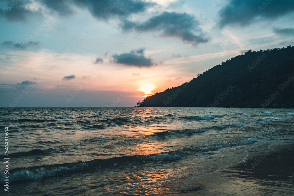 Beautiful scenic landscape with dramatic cloudy sky at sunset and a sun ...