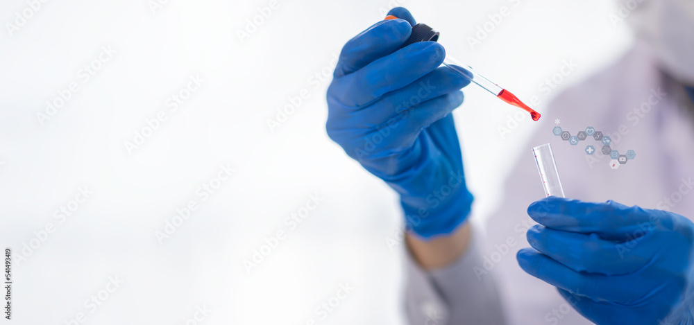 Serious concentrated female microbiologist in sterile clothing and ...