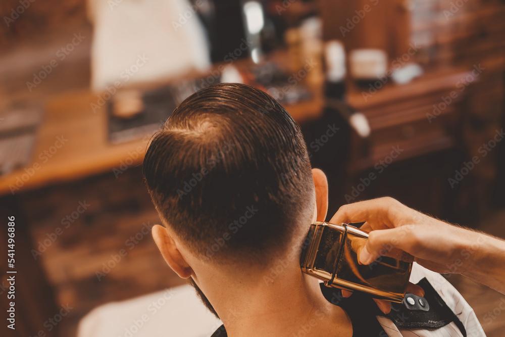 Barbershop concept, vintage color. Closeup man haircut, master does ...