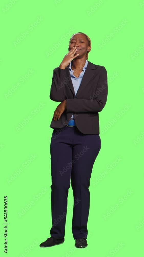 Vertical video: Cheerful woman laughing and acting flirty on green ...