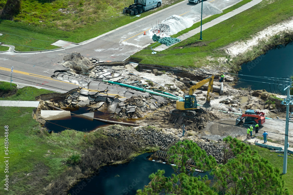 Aerial view of reconstruction of damaged road bridge destroyed by river ...