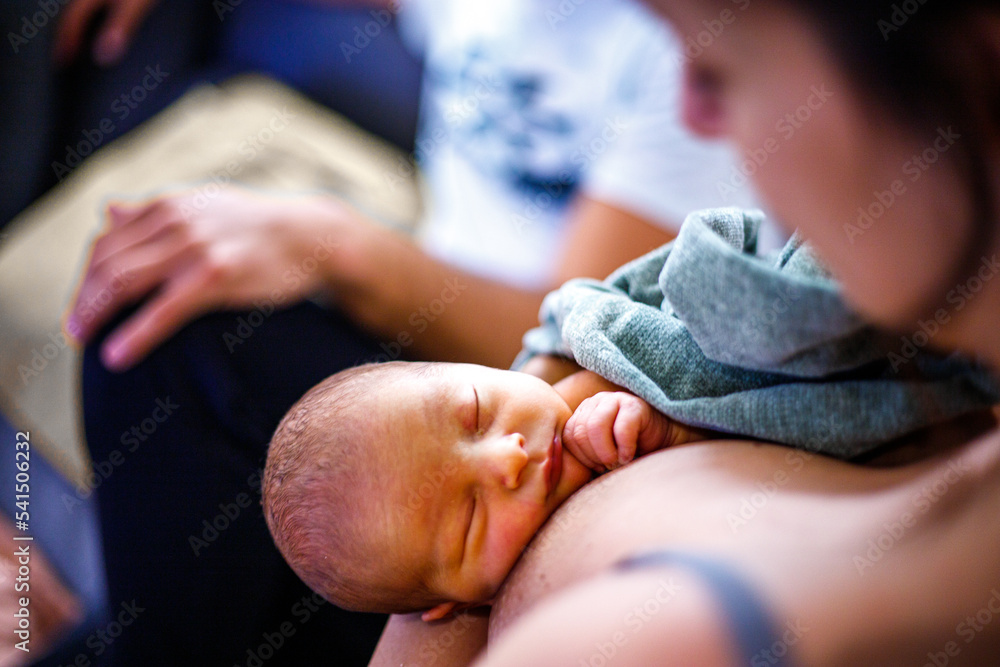 Crop mother breast feeding newborn baby Stock Photo | Adobe Stock
