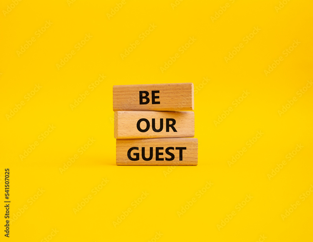Be our guest symbol. Concept word Be our guest on wooden blocks ...