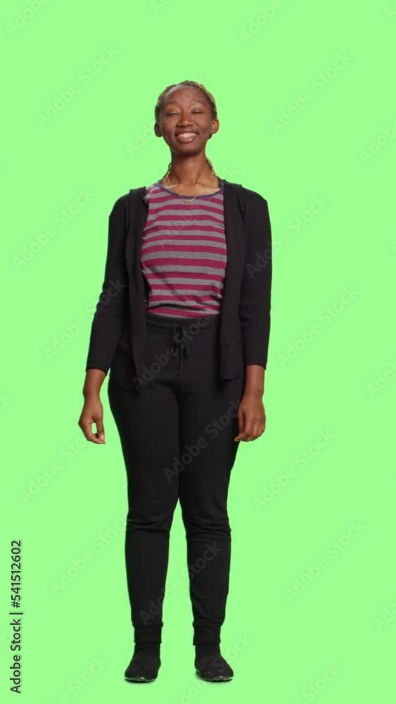 Vertical video: Modern woman looking at 3d hologram over greenscreen ...