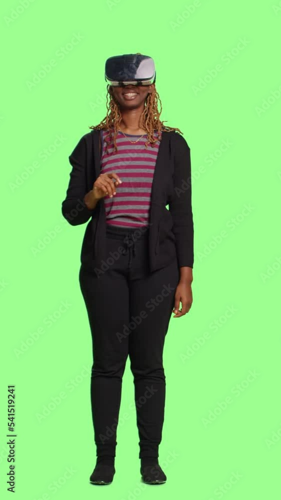 Vertical video: Female model using vr glasses standing on full body ...