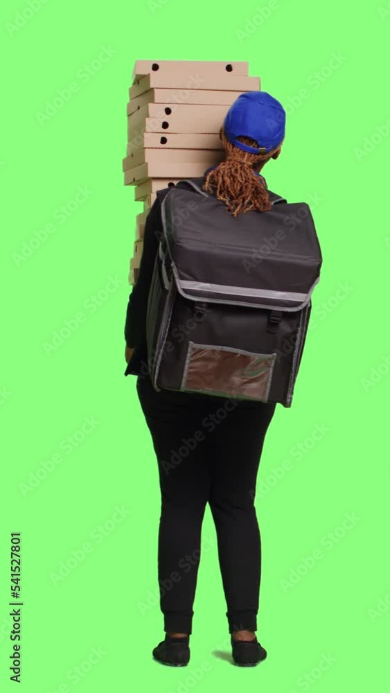 Female model carrying huge pile of pizza boxes to deliver meal on full ...