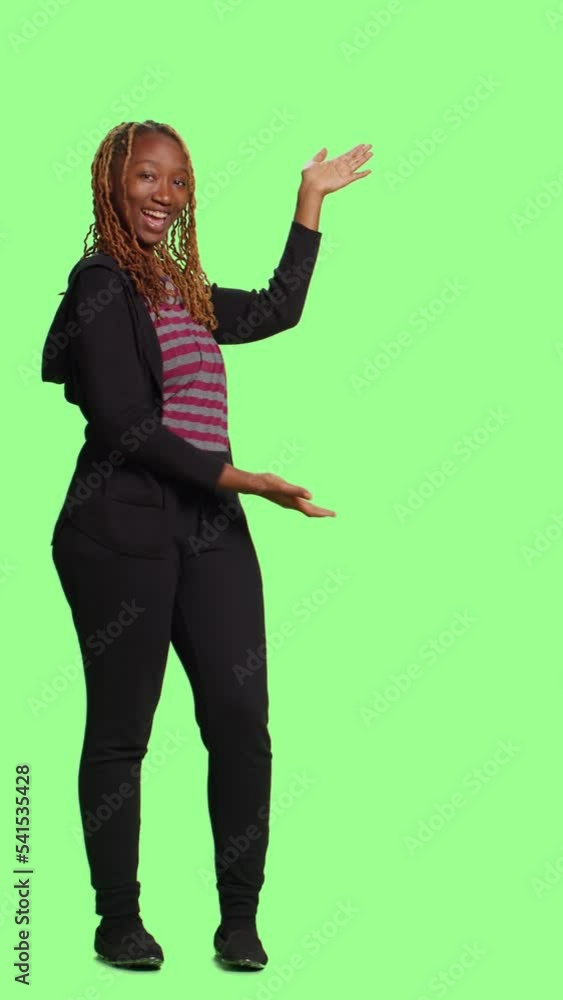 Vertical video: Female model advertising icon over green screen ...