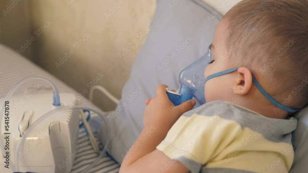 Little 2 years old boy does therapeutic inhalation using a nebulizer ...