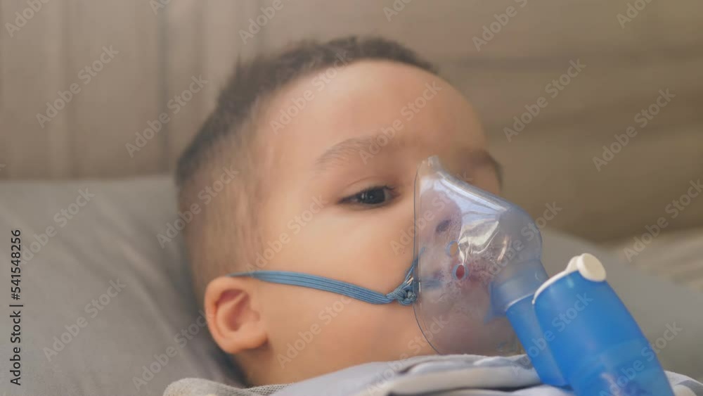 Little 2 years old boy does therapeutic inhalation using a nebulizer ...
