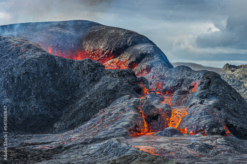 View into the volcanic crater opening after an eruption. hot glowing ...