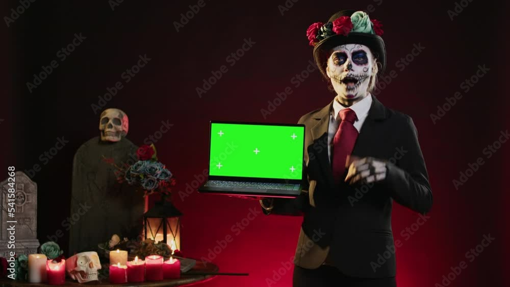 Glamorous holy entity holding laptop with greenscreen display, showing ...