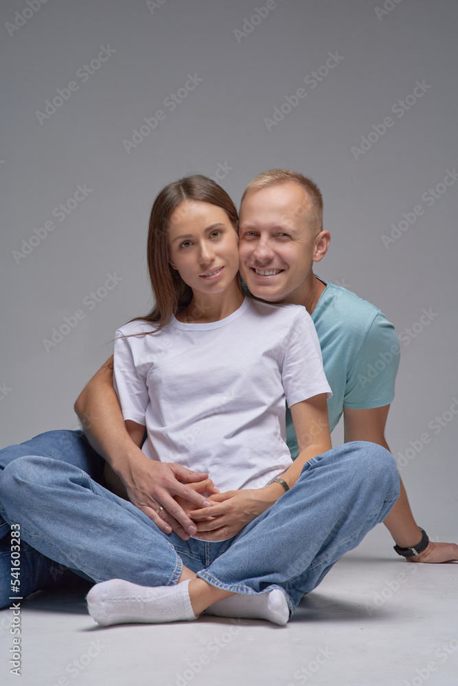 Young beautiful couple in love on a white background. Gently hug and ...