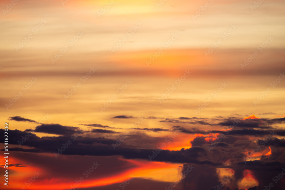 The dramatic colors of the sunset in the sky gradient from blue to ...