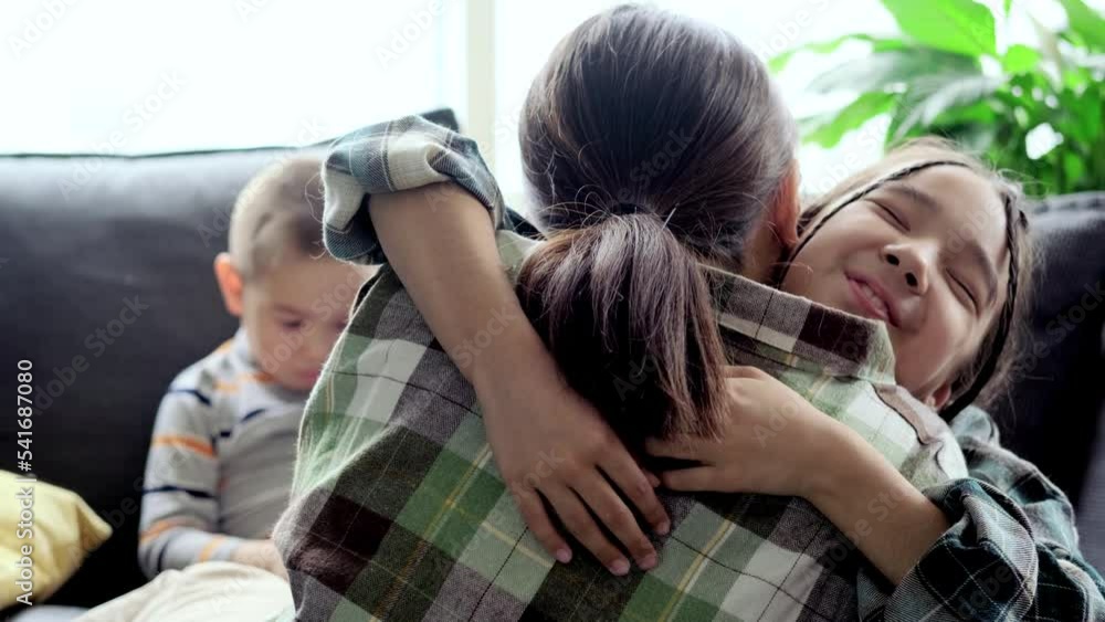 The little daughter hugs her mother tightly. Kiss and hug the happy ...