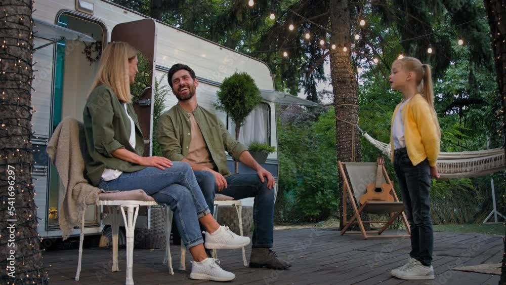 Caucasian mother and adult bearded father in camping near van trailer ...