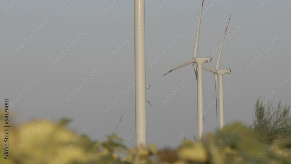 Wind turbine heads with a green flora in foreground. Stock Video ...