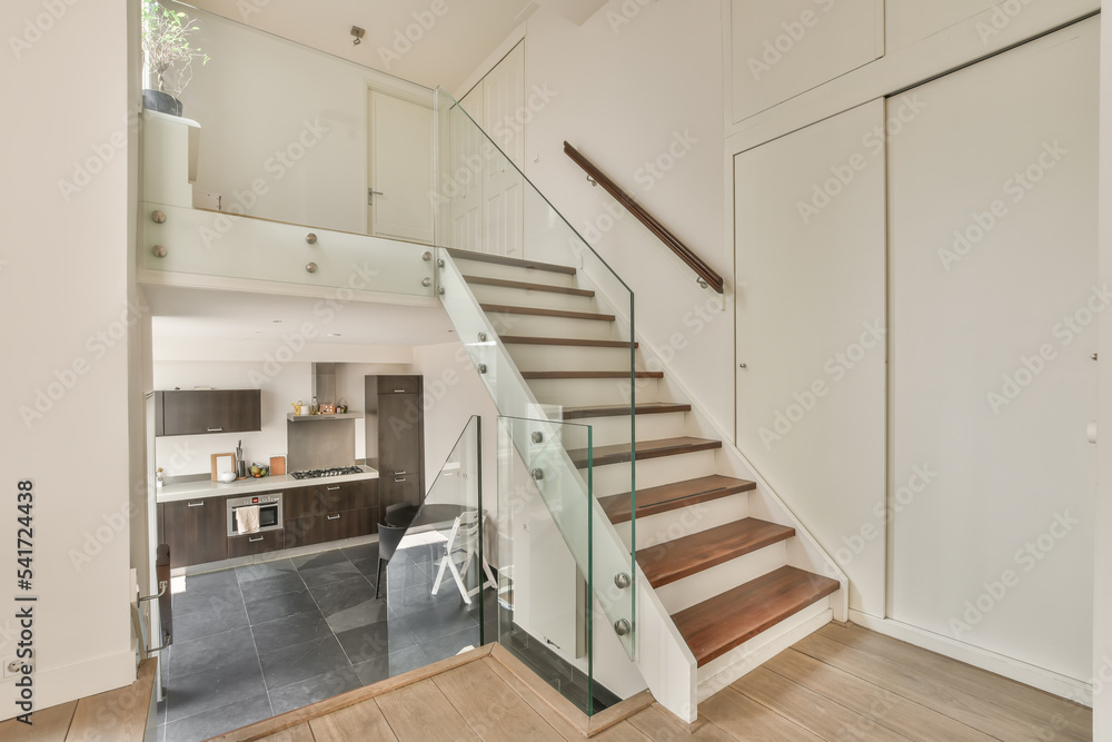 Kitchen under staircase leading to second floor Stock Photo | Adobe Stock