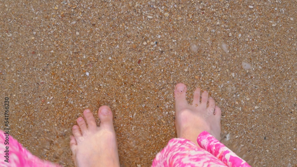 View from above woman leg in the sea beach and the wave splashes at ...