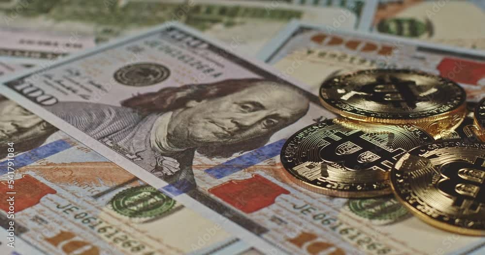 Bitcoin crypto-currency stacked with 100 dollar bills, close up ...