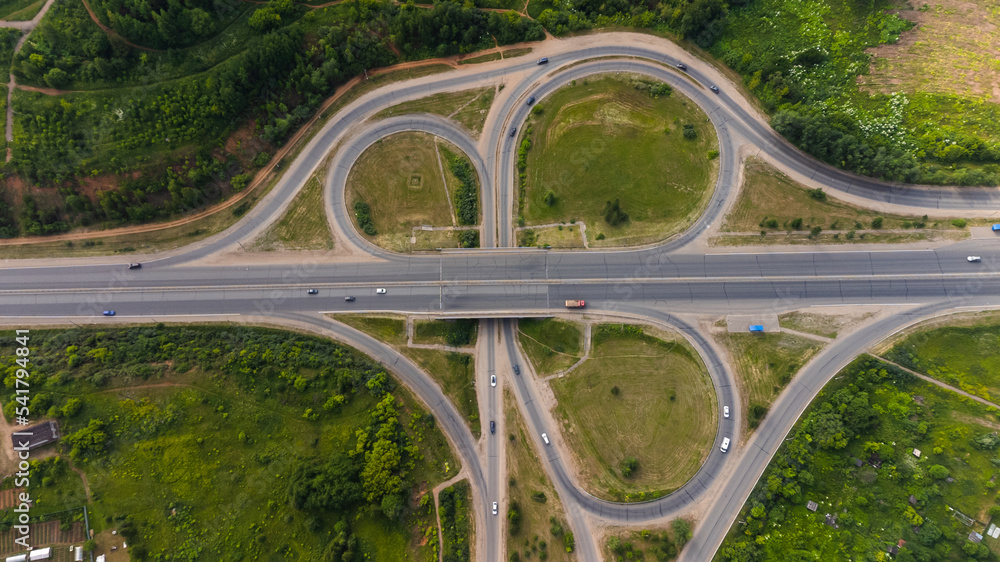 Aerial view of highway in city. Cars crossing interchange overpass ...
