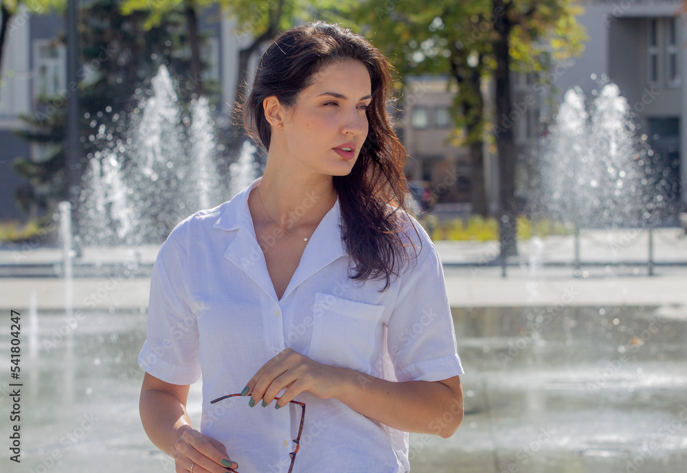 Urban portrait of a young elegant business woman against the background ...