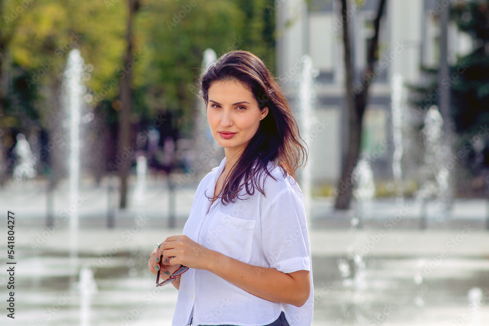 Urban portrait of a young elegant business woman against the background ...