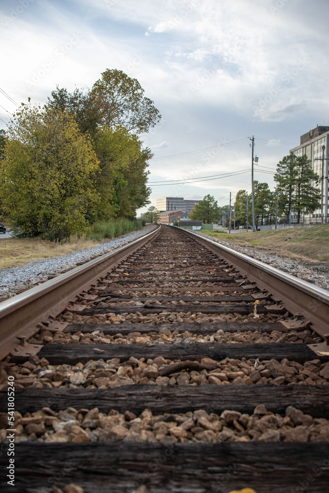 Long Railroad Train Tracks with Buildings and a Pretty Sky in the ...