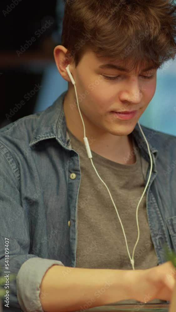Teenage student learning at home with books and laptop computer. Online ...