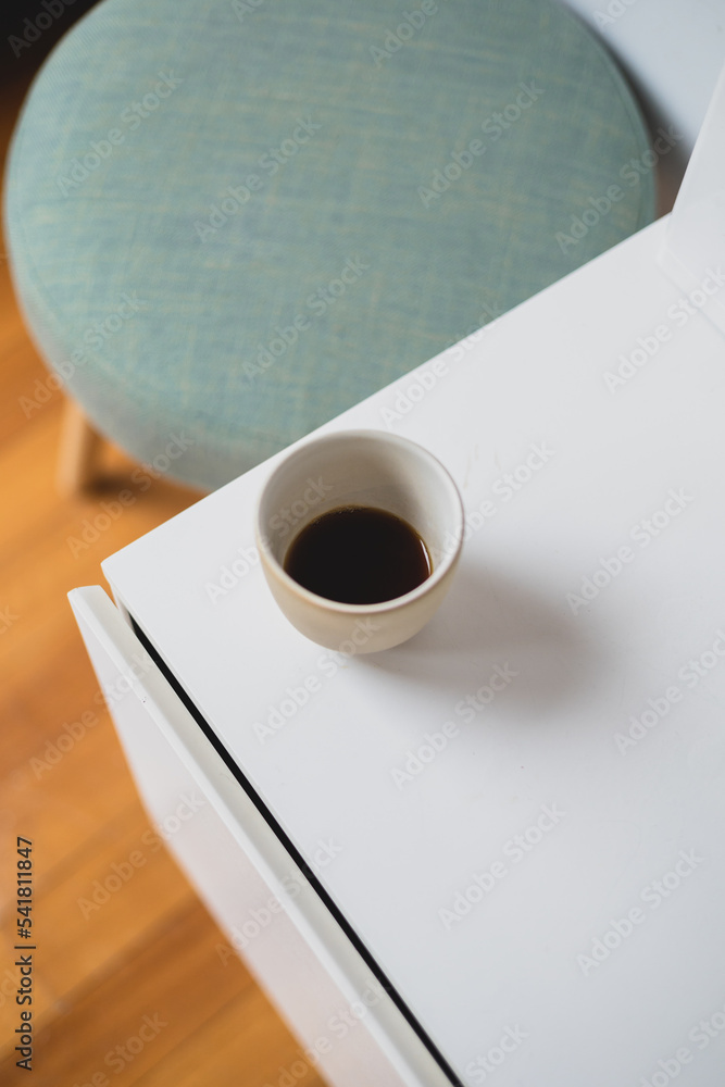white cup of brewed coffee on a white table Stock Photo | Adobe Stock
