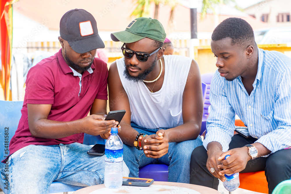 image of african men with smartphone- black guys enjoying social media ...