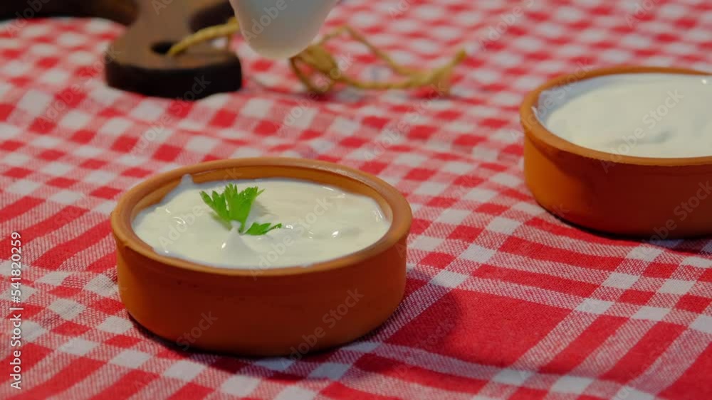 With spoon fresh yogurt close up.Mixing yogurt in bowl.4K UHD video ...