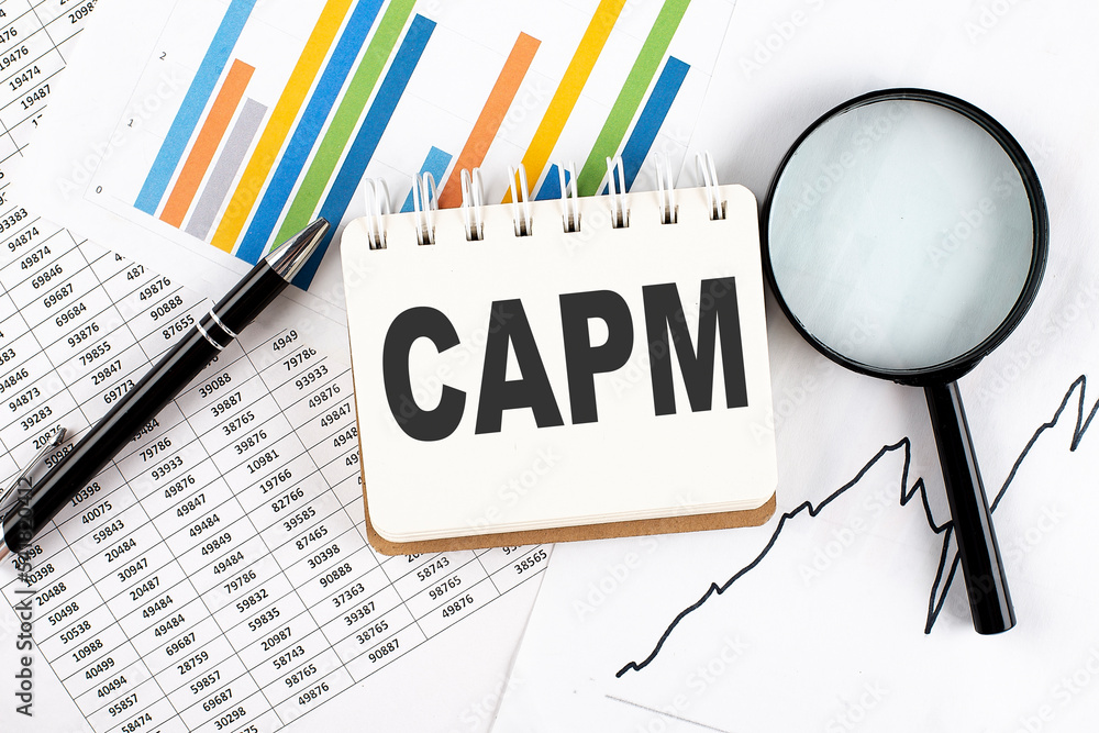 CAPM on notebook on the graph background with pen and magnifier Stock ...
