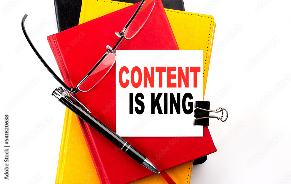 CONTENT IS KING text written on a sticky on colorful notebooks Stock ...