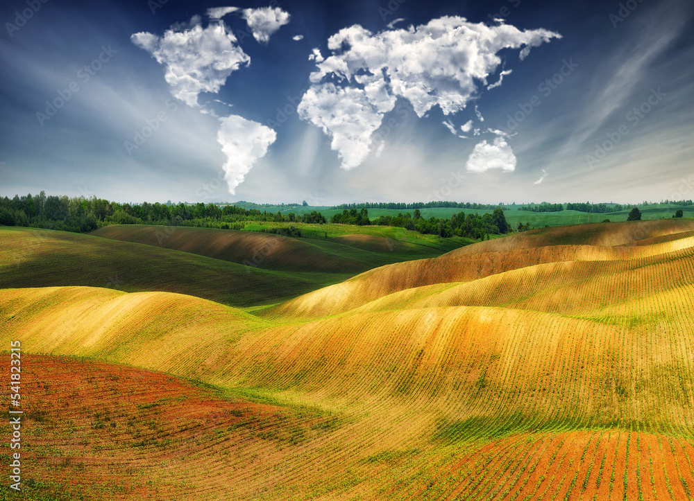 clouds in the form of a map of the world over the field. Travel and ...