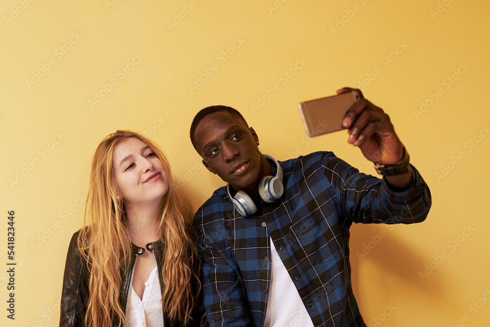 Diverse couple taking selfie together Stock Photo | Adobe Stock