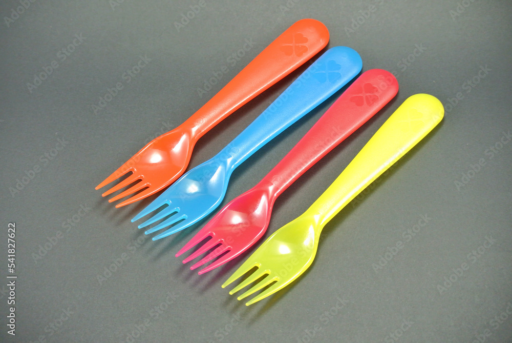 Colorful plastic forks on black background Stock Photo | Adobe Stock