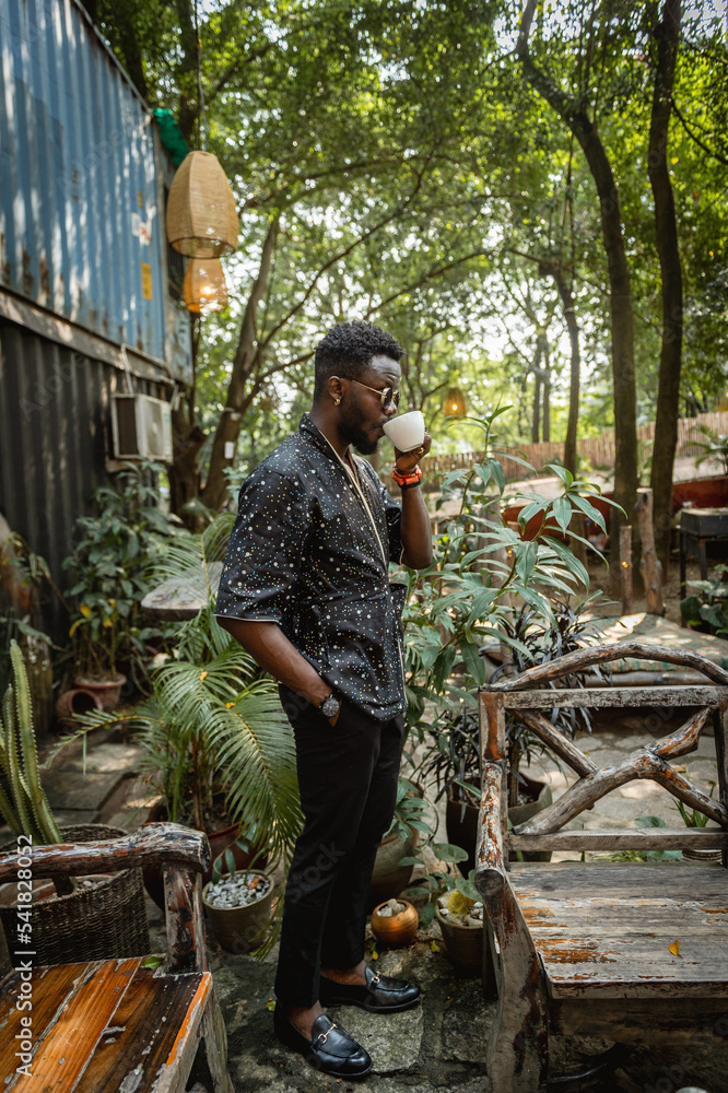 black man in a kimono standing and drinking tea Stock Photo | Adobe Stock