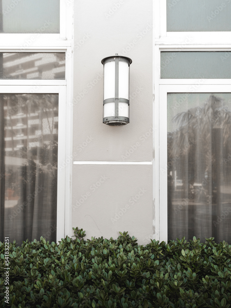 Nature bush and a modern light resource in wall with two windows Stock ...