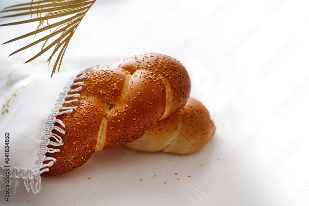 Challah bread covered with a special napkin on white background ...