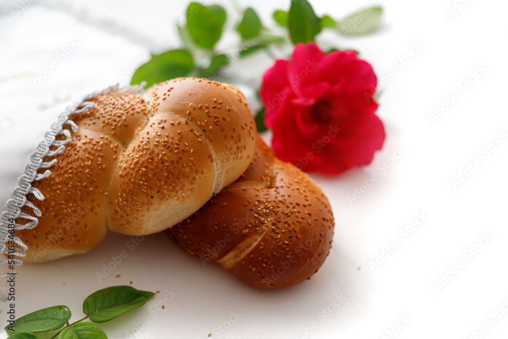 Challah bread covered with a special napkin on white background ...