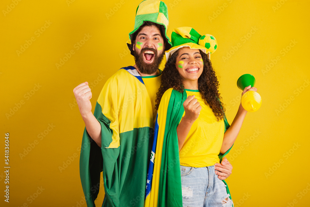 couple of brazil soccer supporters, dressed in the colors of the nation ...