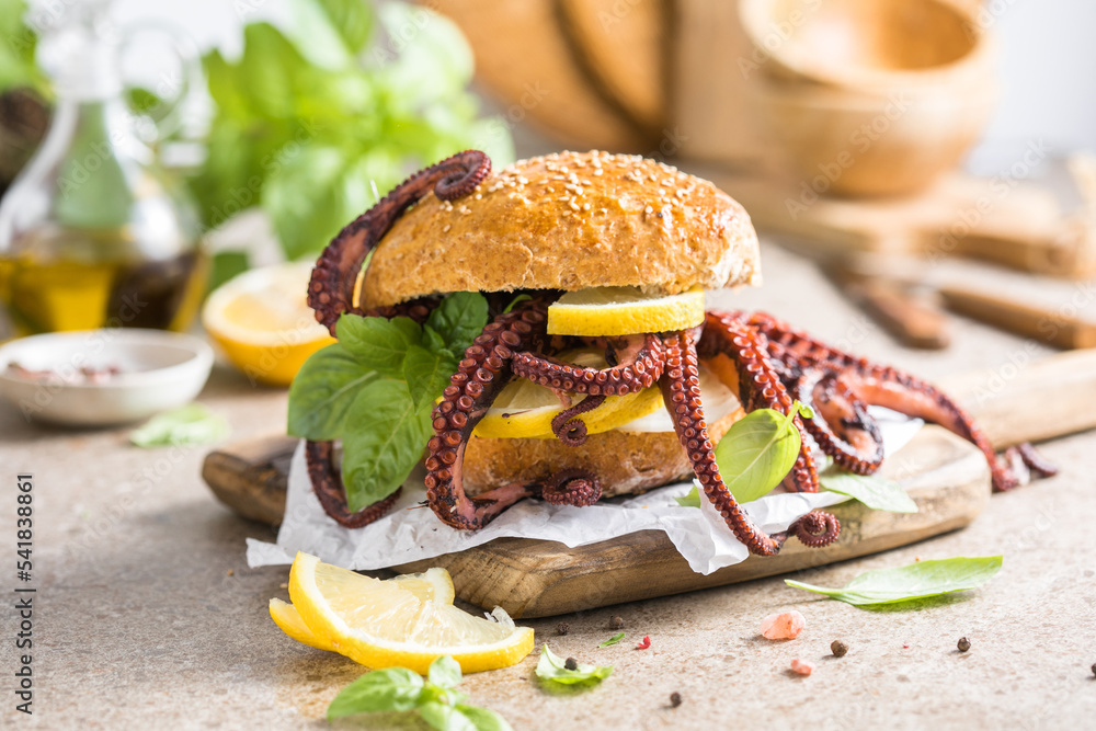 Big burger with octopus and lemon. Large sandwich stuffed with seafood ...