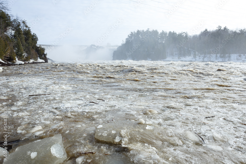 Chaudiere river and falls in winter, ice breaking up. Levis, Quebec ...