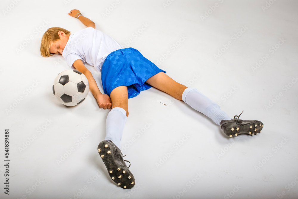 Young male soccer player lying unconscious injured on the ground Stock ...