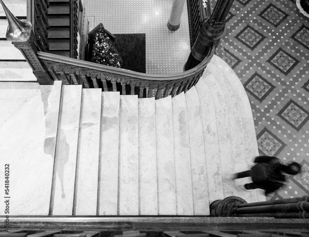 A black and white image of a holiday scene in a hotel depicting a man ...