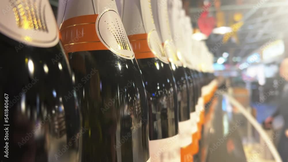 Champagne bottles line up in a liquor store, ABC store, or supermarket ...