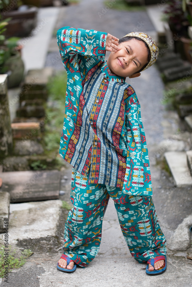 Asian Muslim boy making cute poses in Muslim clothes Stock Photo ...