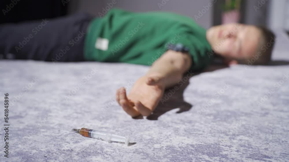 Drug addicted man is unconscious from overdose. The man who takes a ...